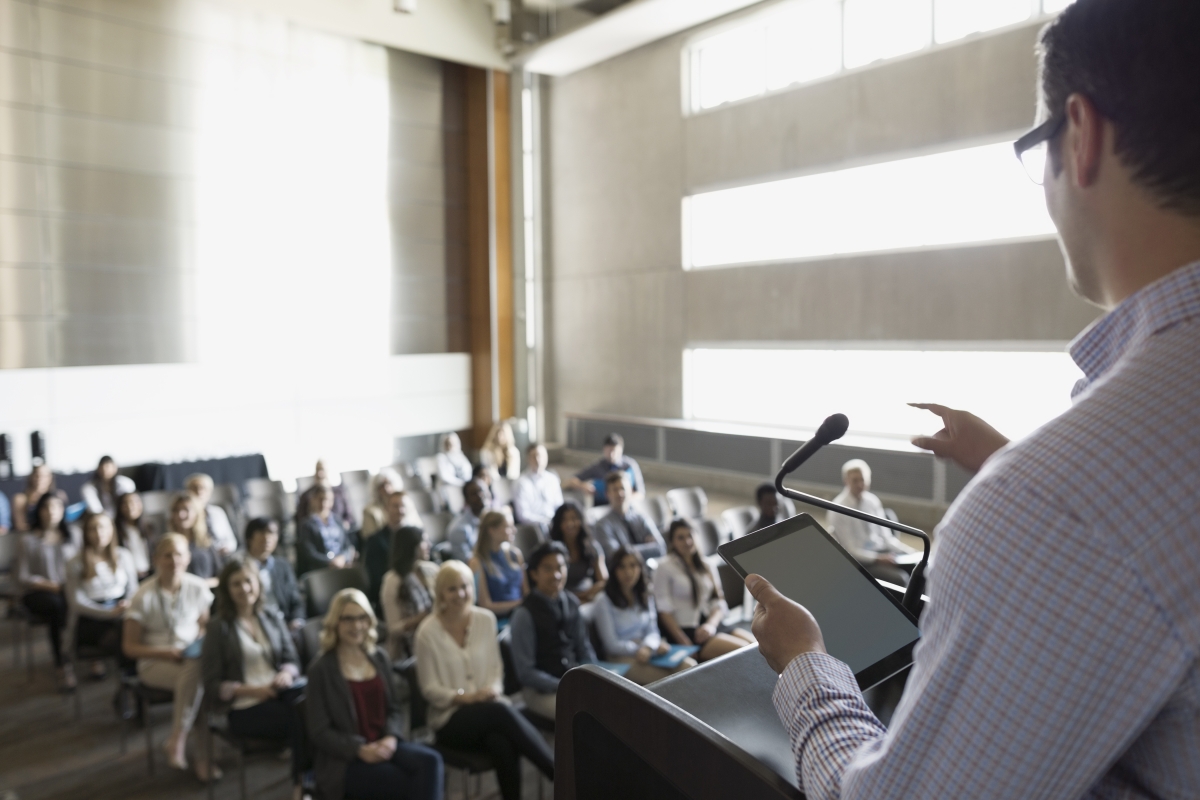 Professor with digital tablet speaking to students auditorium • Advance ...