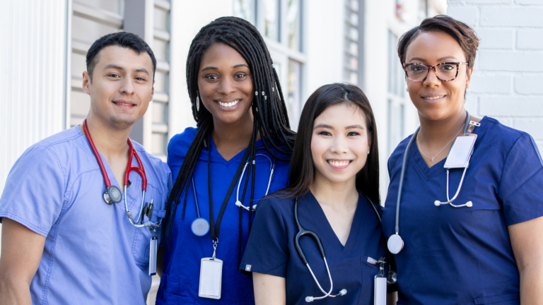 Diverse group of four nursing students standing together outdoors ...